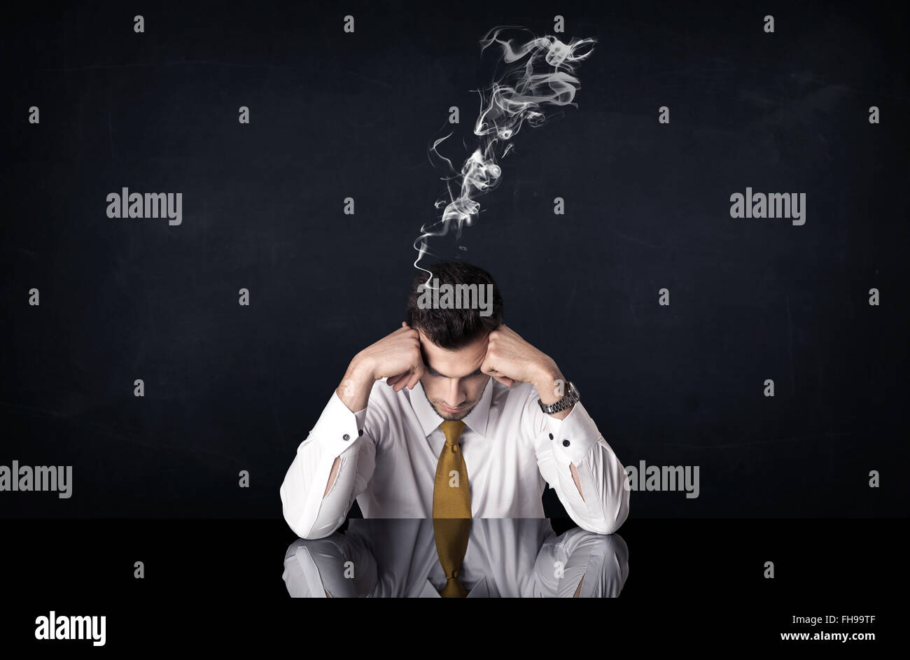 Depressed businessman with smoking head Stock Photo - Alamy
