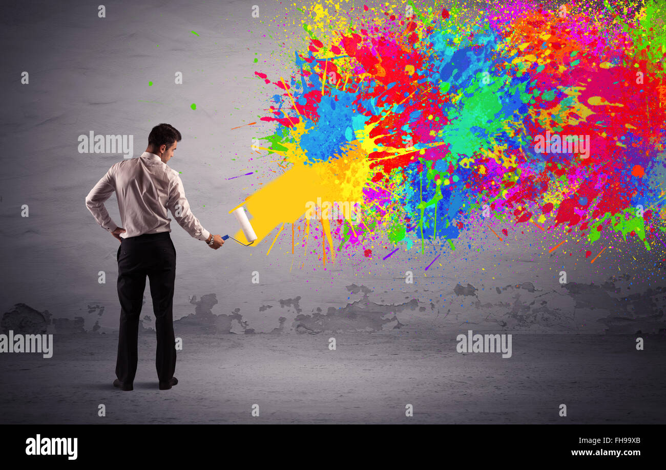 Sales person painting colorful splatter Stock Photo - Alamy