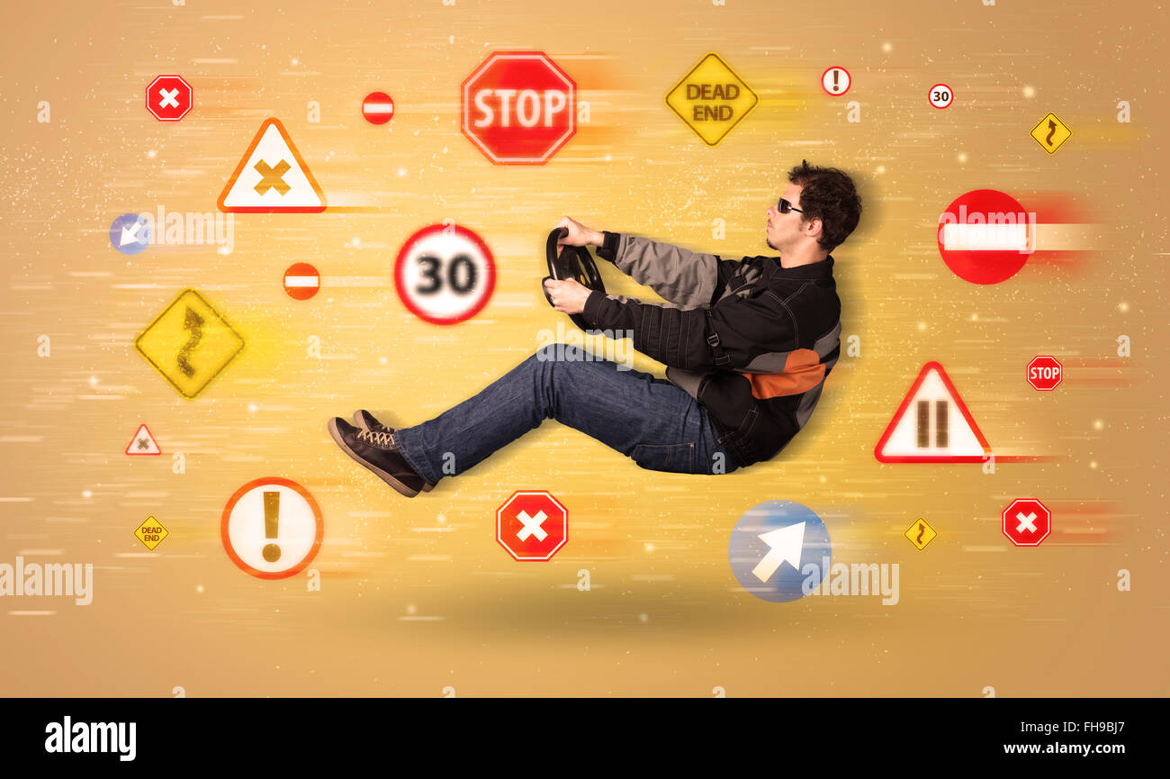 Young driver with road signs around him Stock Photo - Alamy