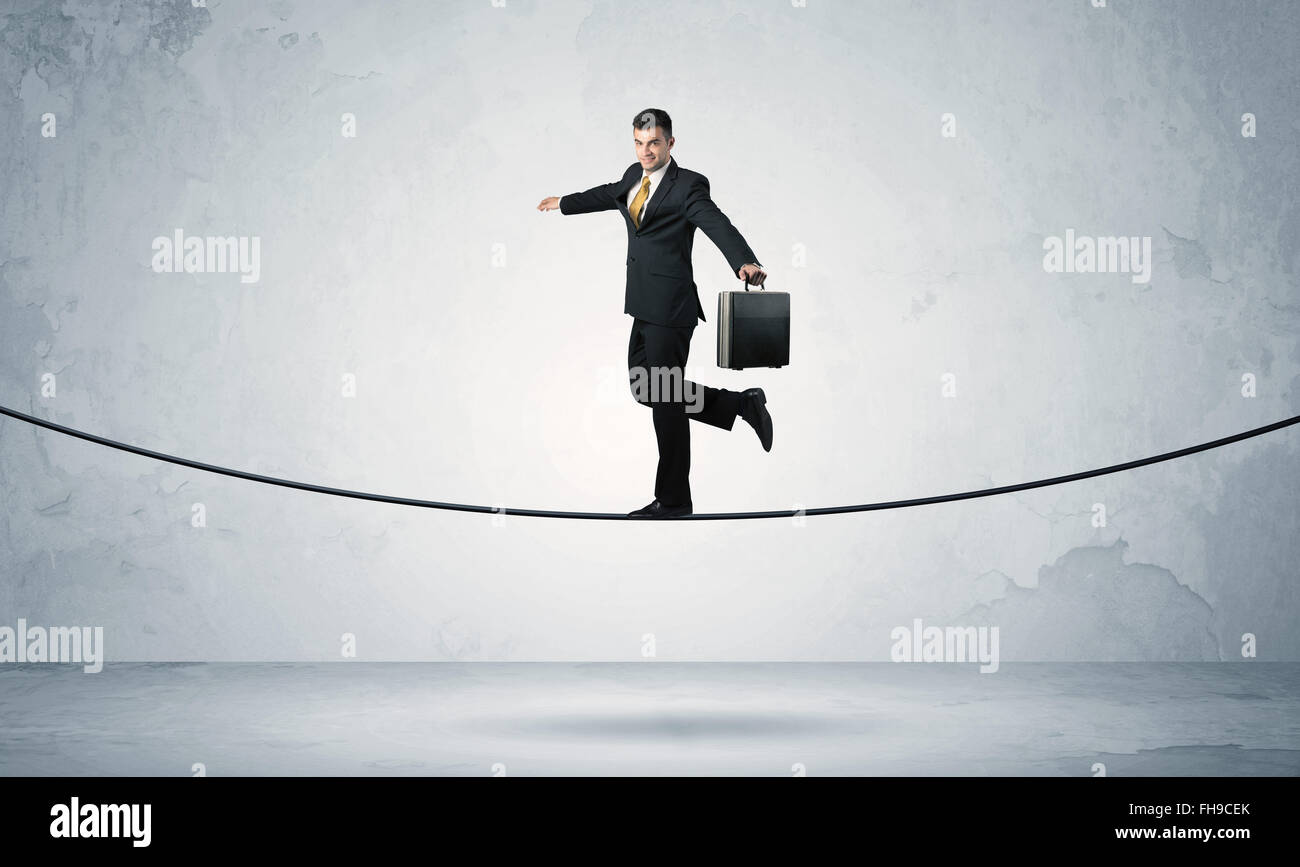 Sales guy balancing on tight rope Stock Photo - Alamy