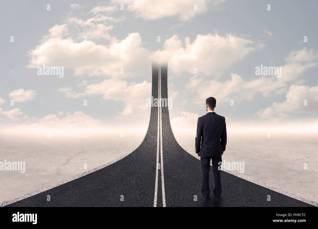 Businessman looking at 3d road that goes up in the sky Stock Photo - Alamy