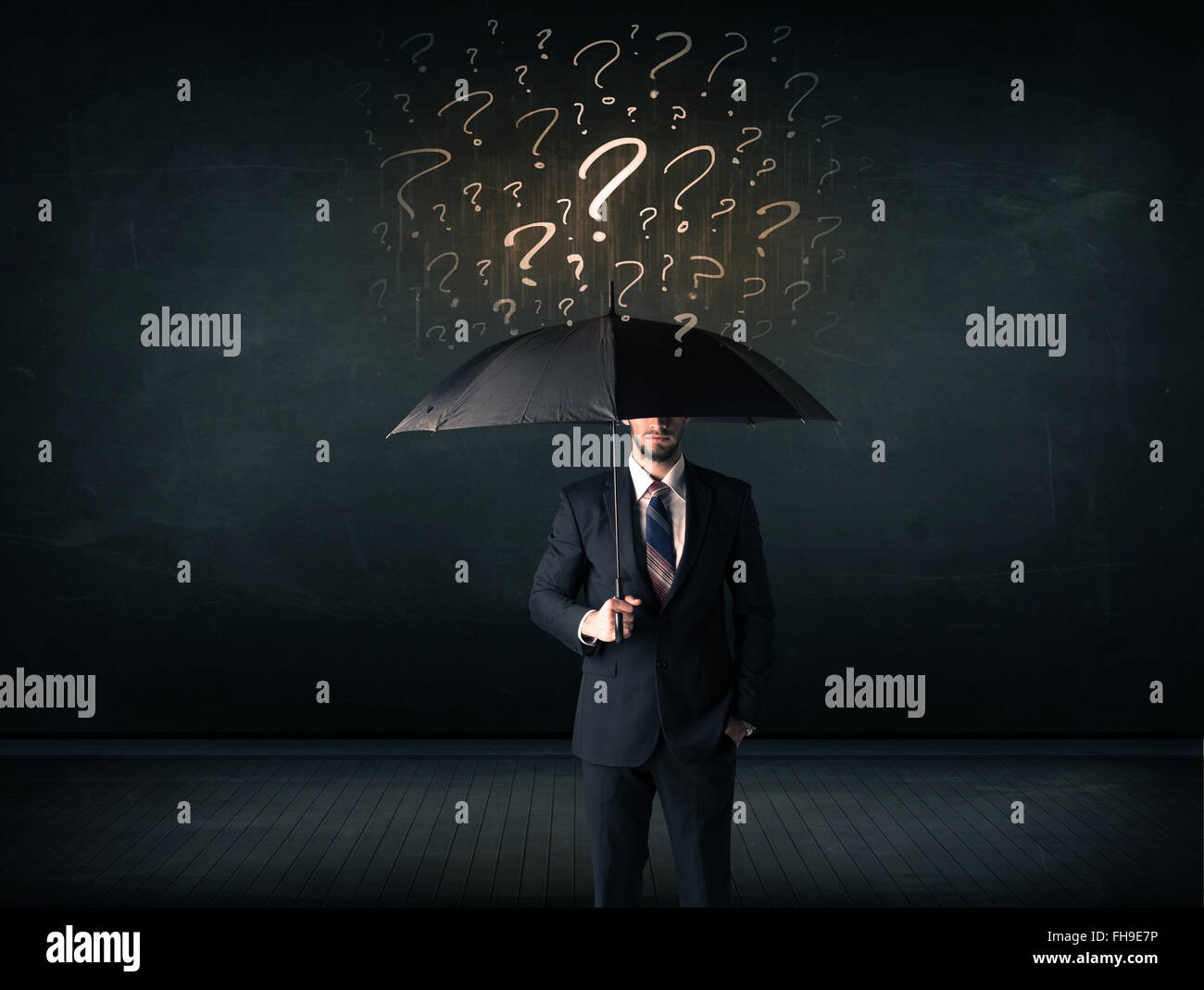 Businessman with umbrella and a lot of drawn question marks Stock Photo ...
