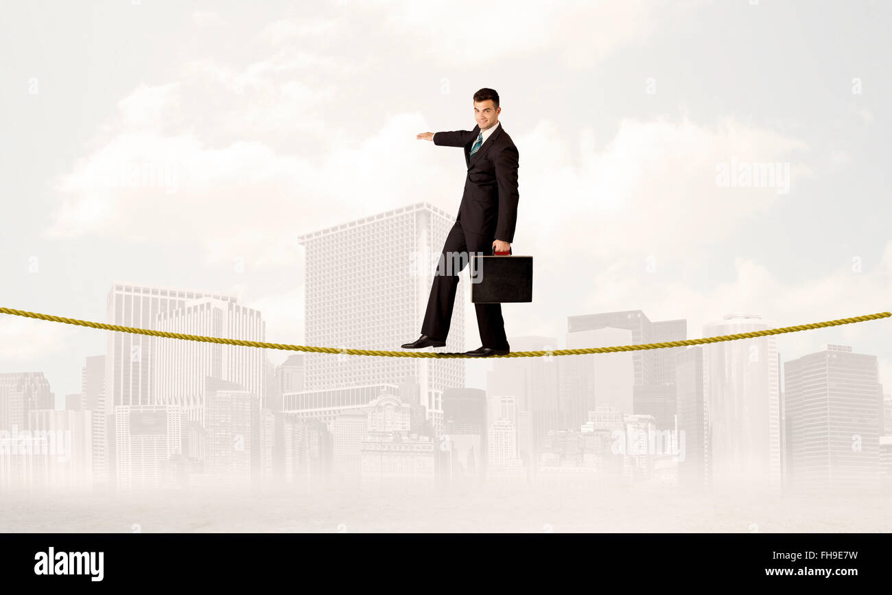 Business person balancing on golden rope Stock Photo - Alamy