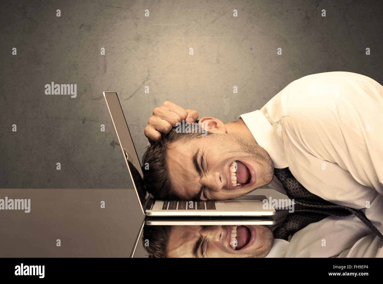 Frustrated businessman's head on keyboard Stock Photo - Alamy