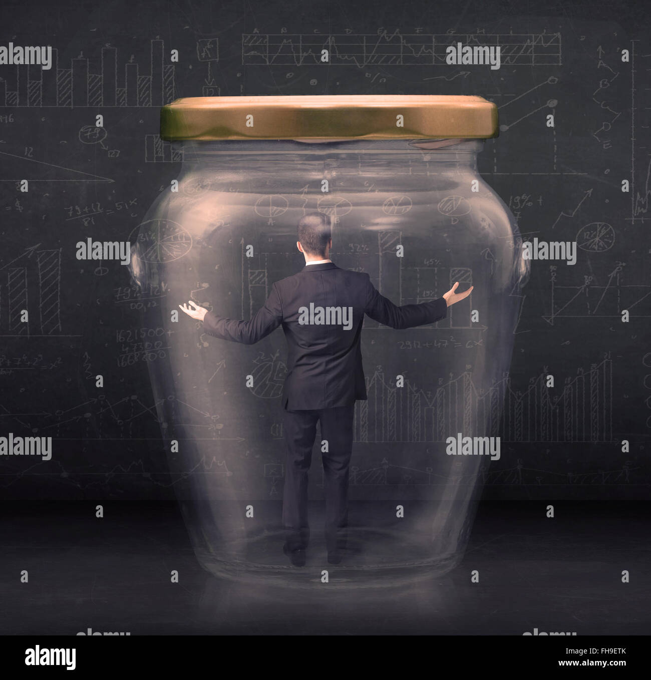 Business man closed into a glass jar concept Stock Photo - Alamy