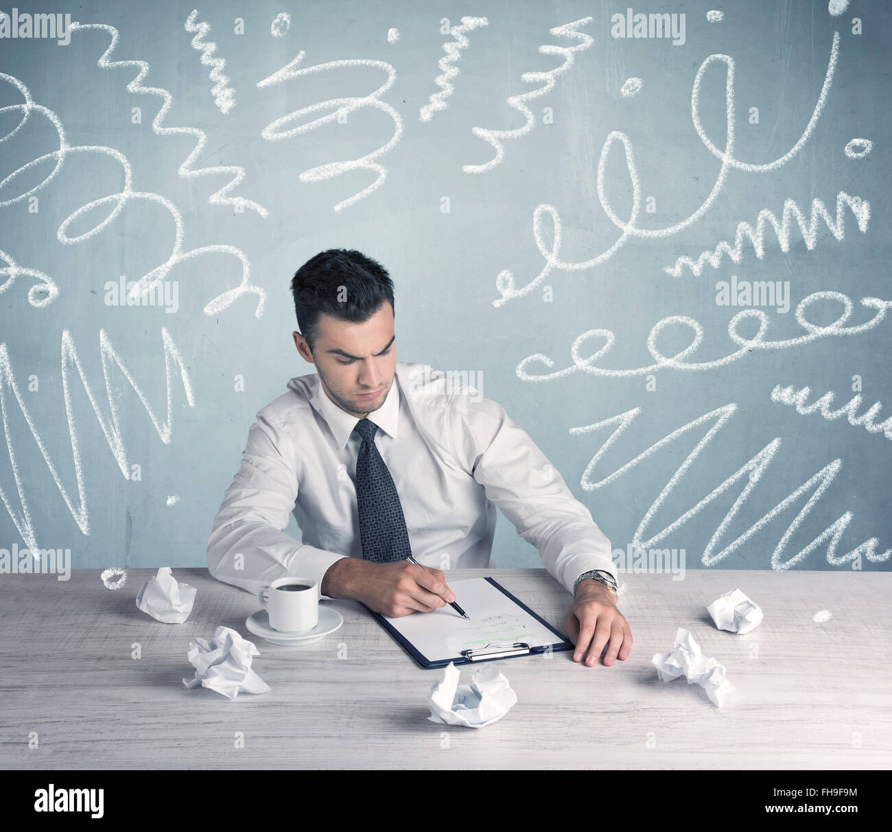 Young man sitting messy desk hi-res stock photography and images - Alamy