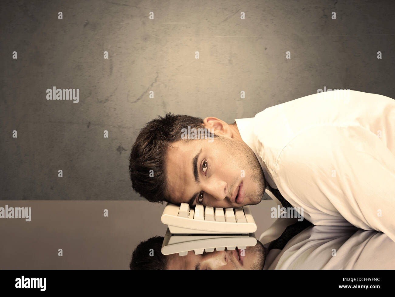Frustrated businessman's head on keyboard Stock Photo - Alamy