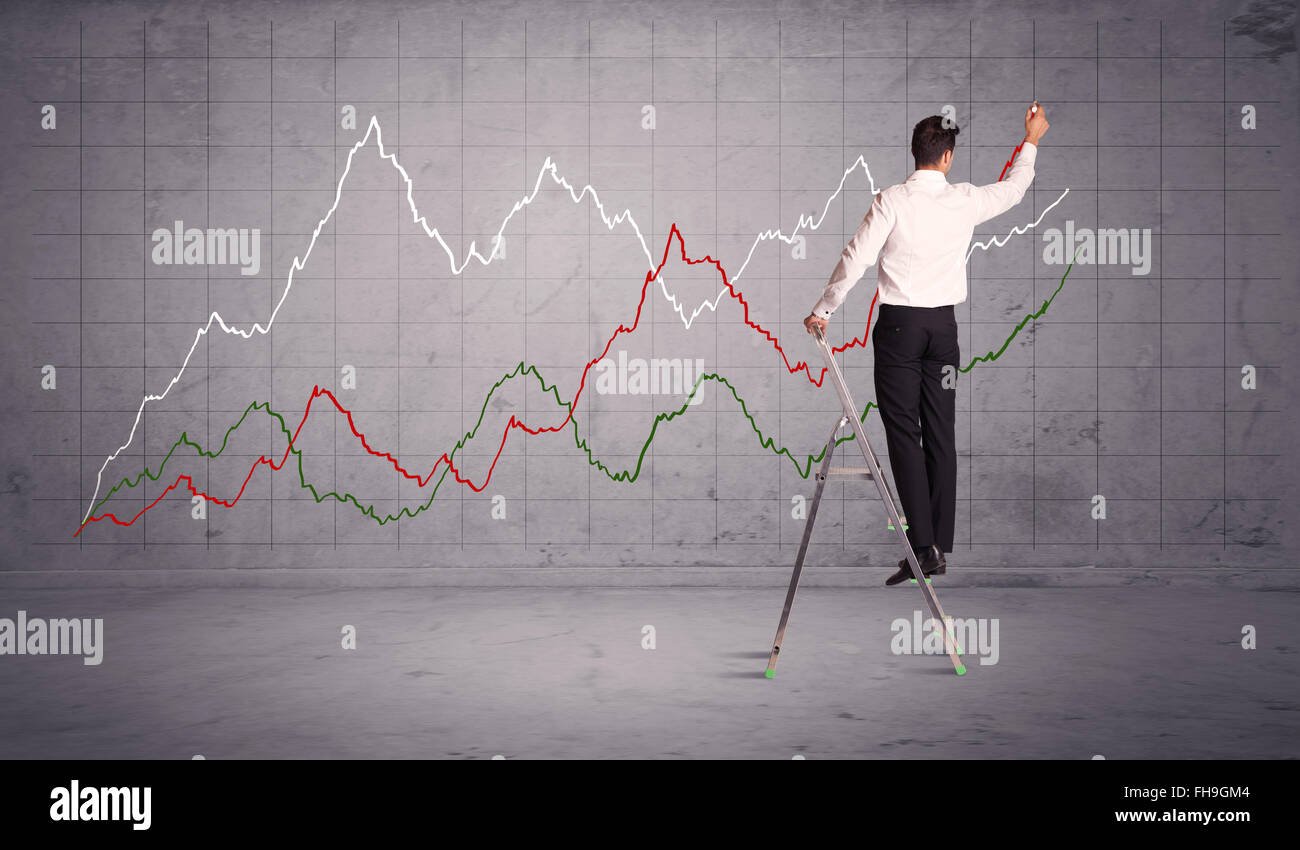 male on ladder drawing chart lines Stock Photo - Alamy