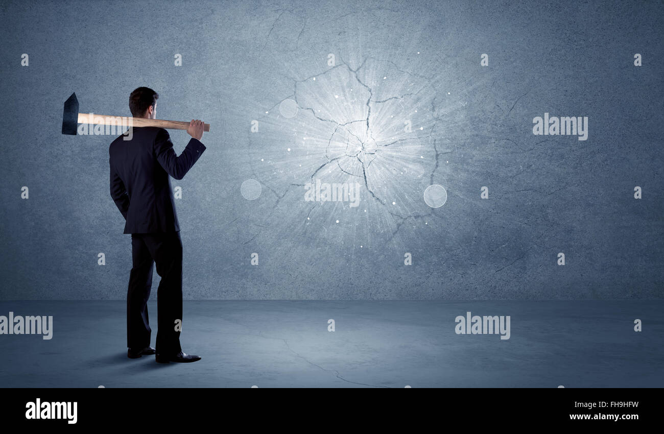 Business man hitting wall with a hammer Stock Photo - Alamy