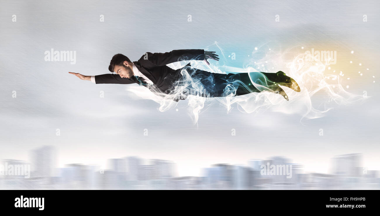 Hero superman flying above city with smoke left behind Stock Photo - Alamy