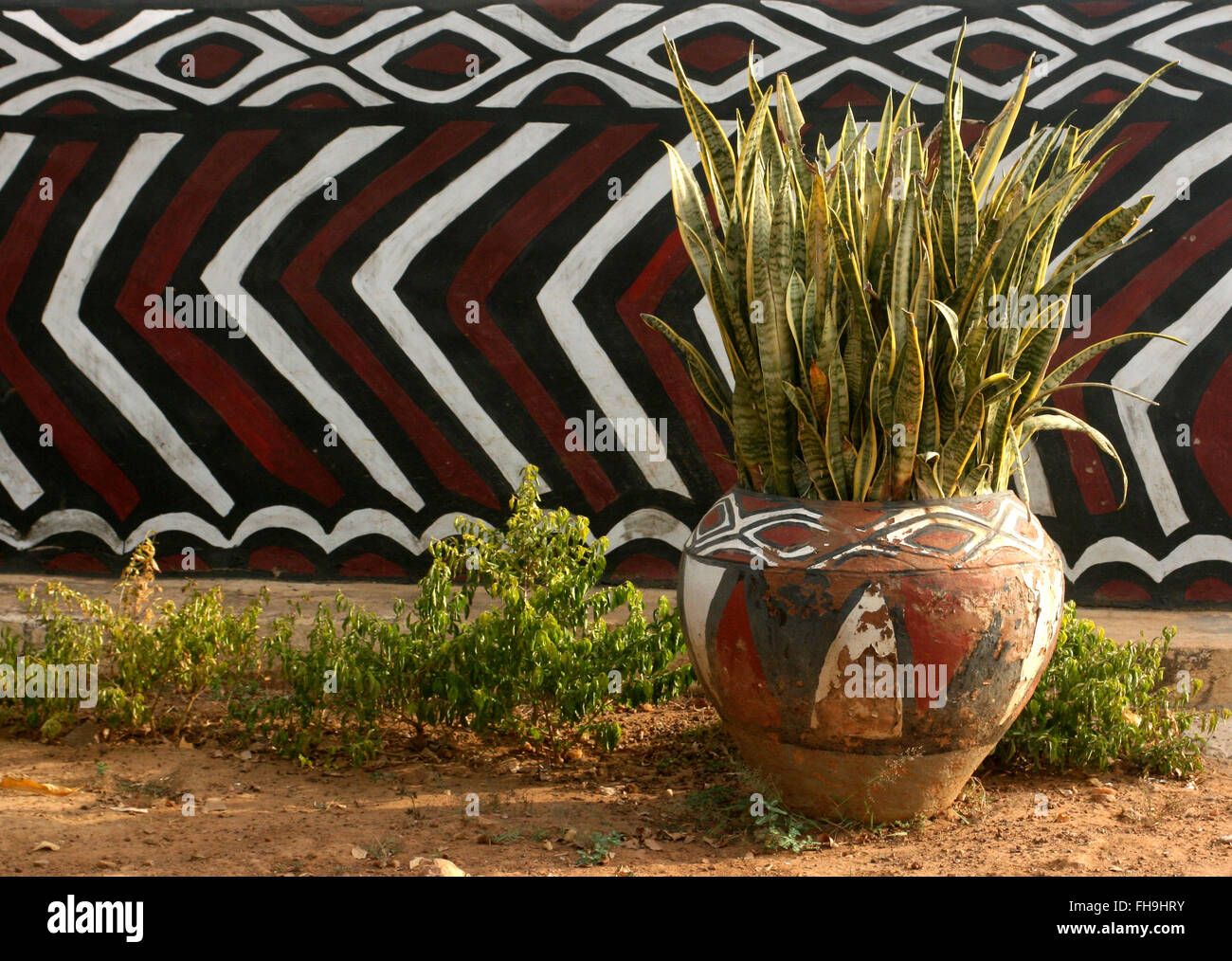 African courtyard with painted mud wall and potted plant Stock Photo ...