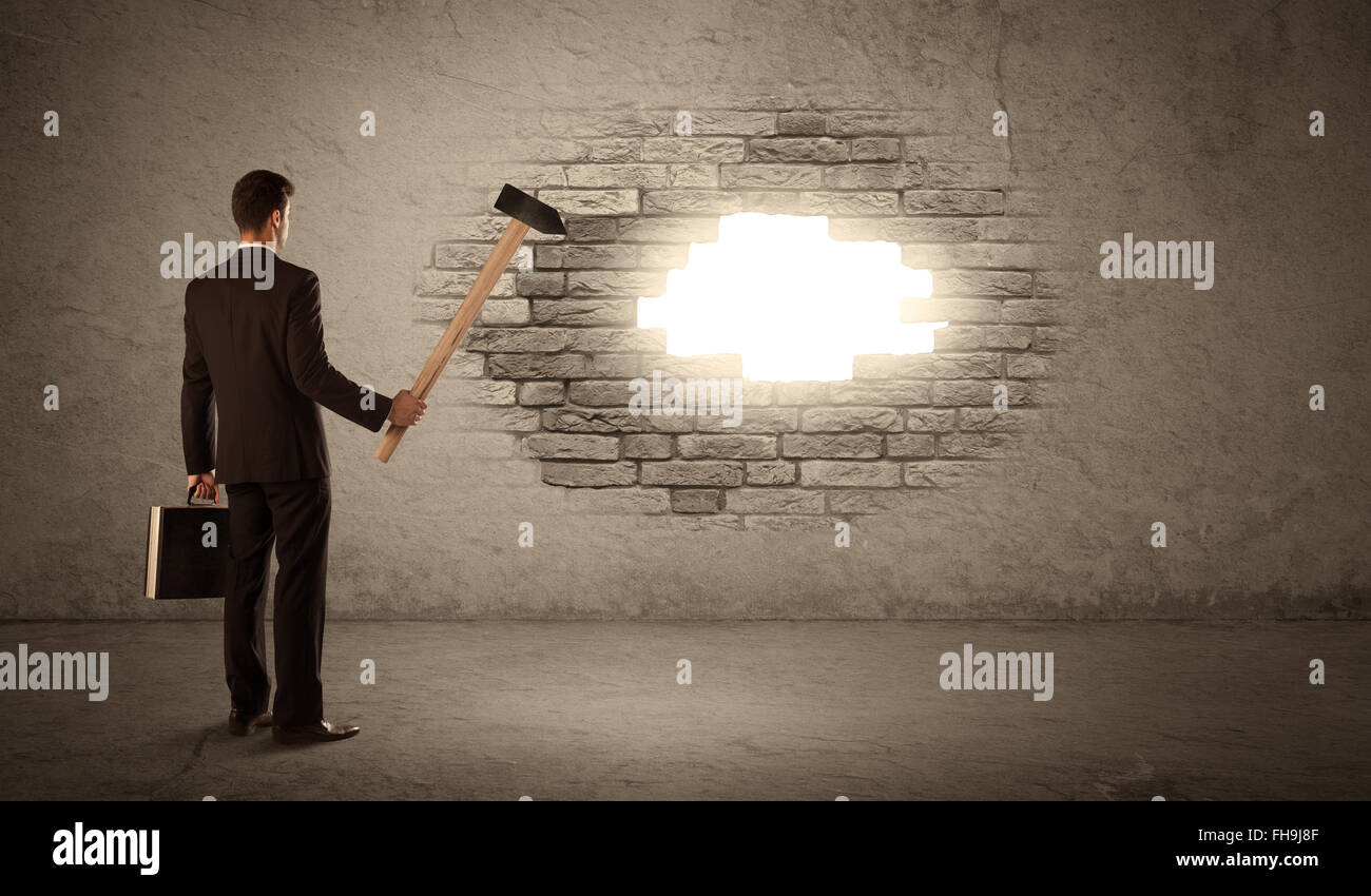 Business man hitting brick wall with hammer and opening a hole Stock ...