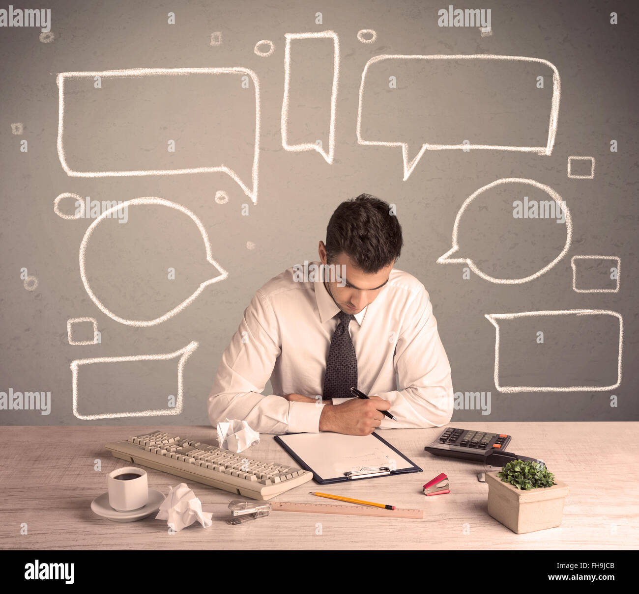 Busy office worker with drawn text bubbles Stock Photo - Alamy