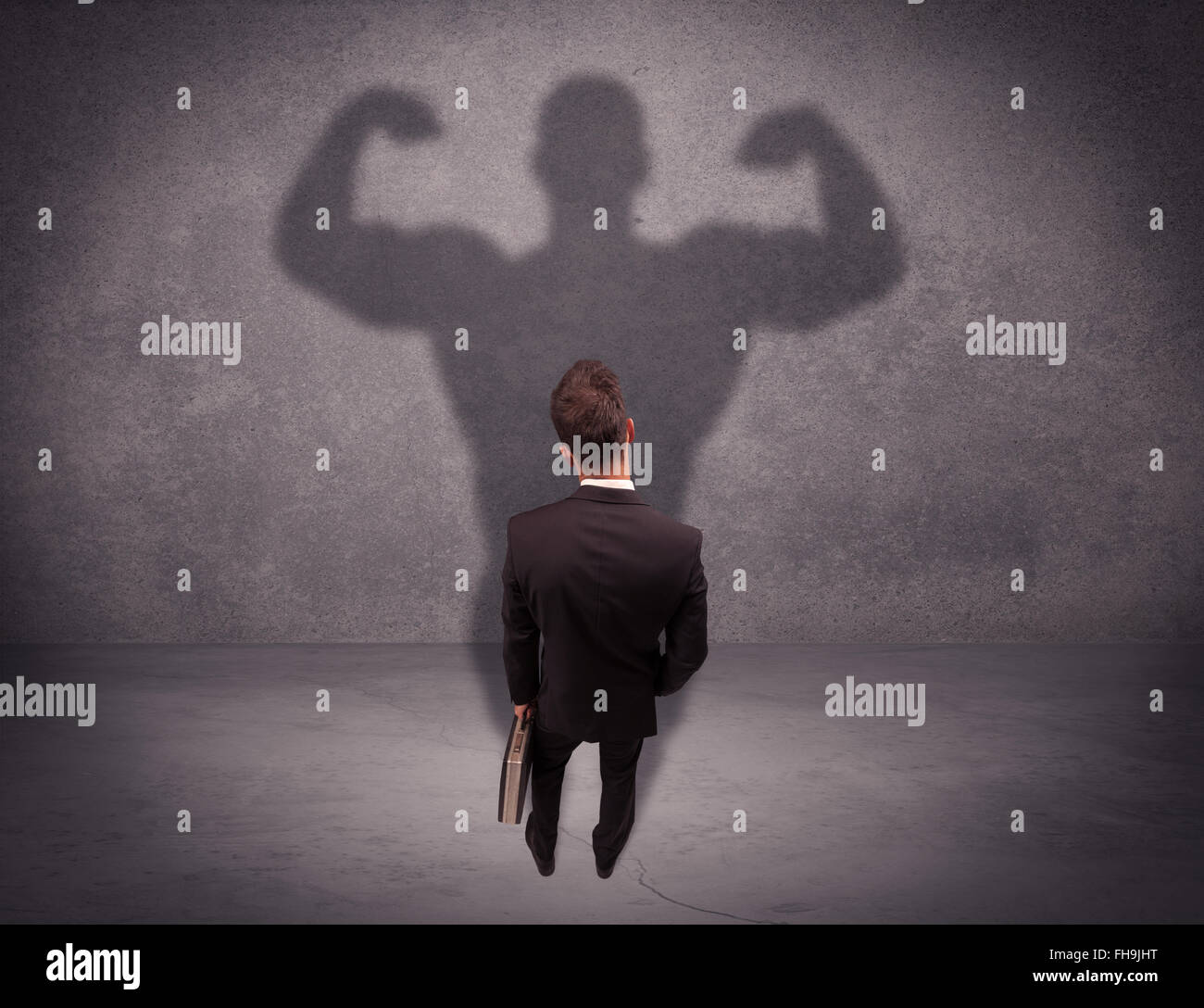 Successful businessman with strong shadow Stock Photo - Alamy