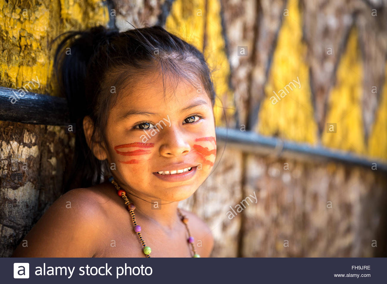 Native Brazilian girl smiling at an indigenous tribe in the Amazon ...