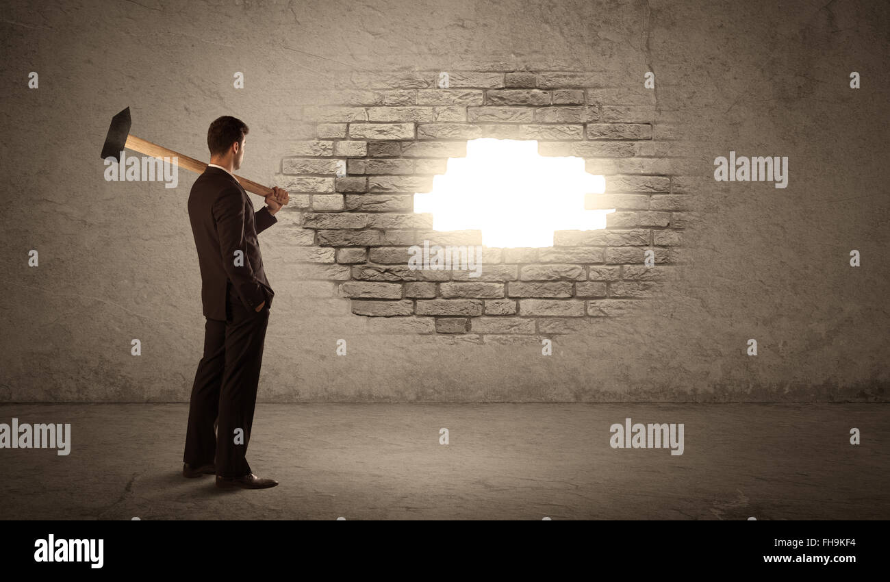 Business man hitting brick wall with hammer and opening a hole Stock ...