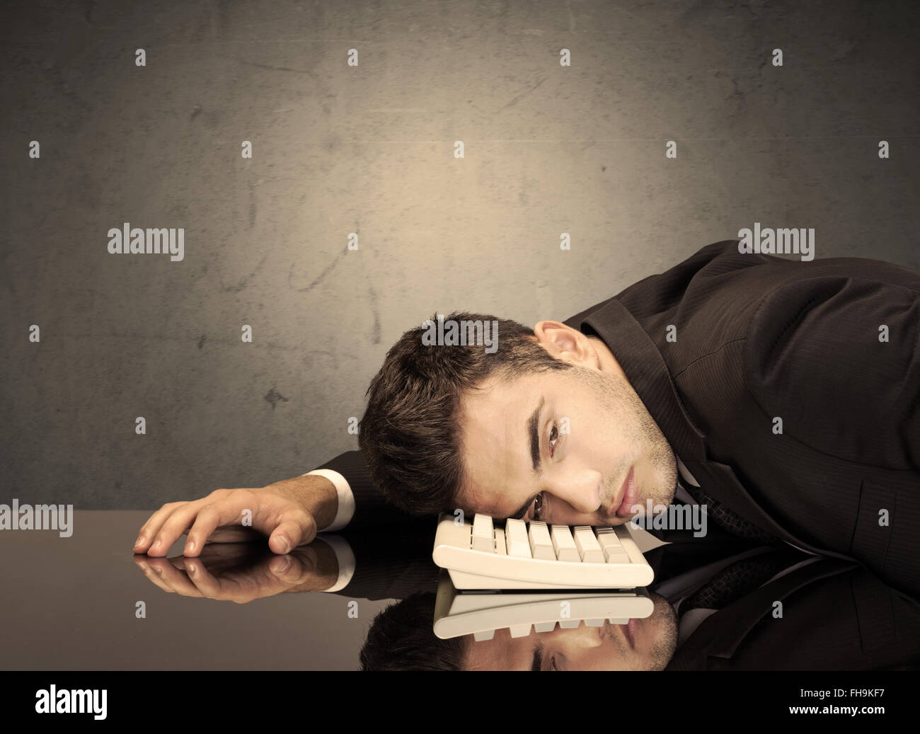 Frustrated businessman's head on keyboard Stock Photo - Alamy