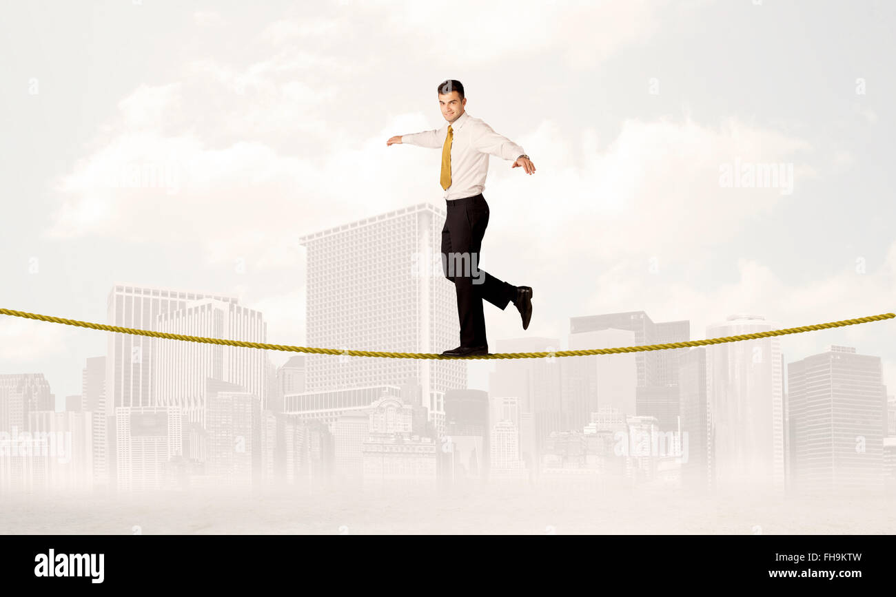 Business person balancing on golden rope Stock Photo - Alamy