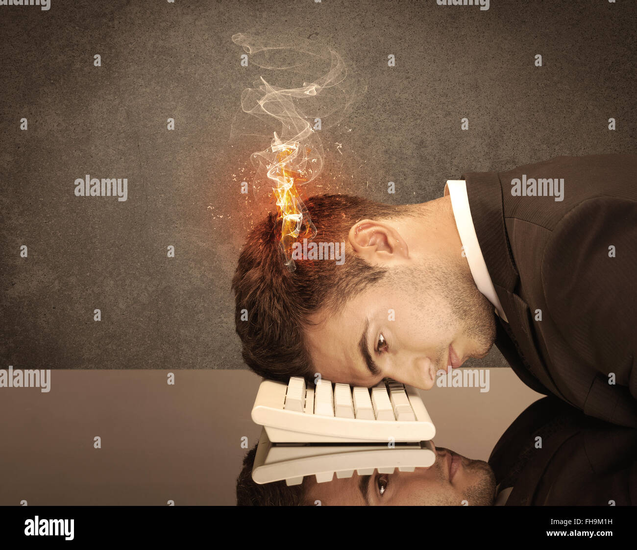 Sad business person's head catching fire Stock Photo - Alamy