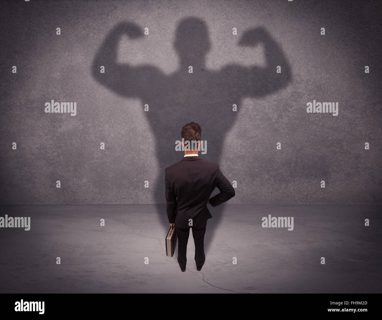 Successful businessman with strong shadow Stock Photo - Alamy