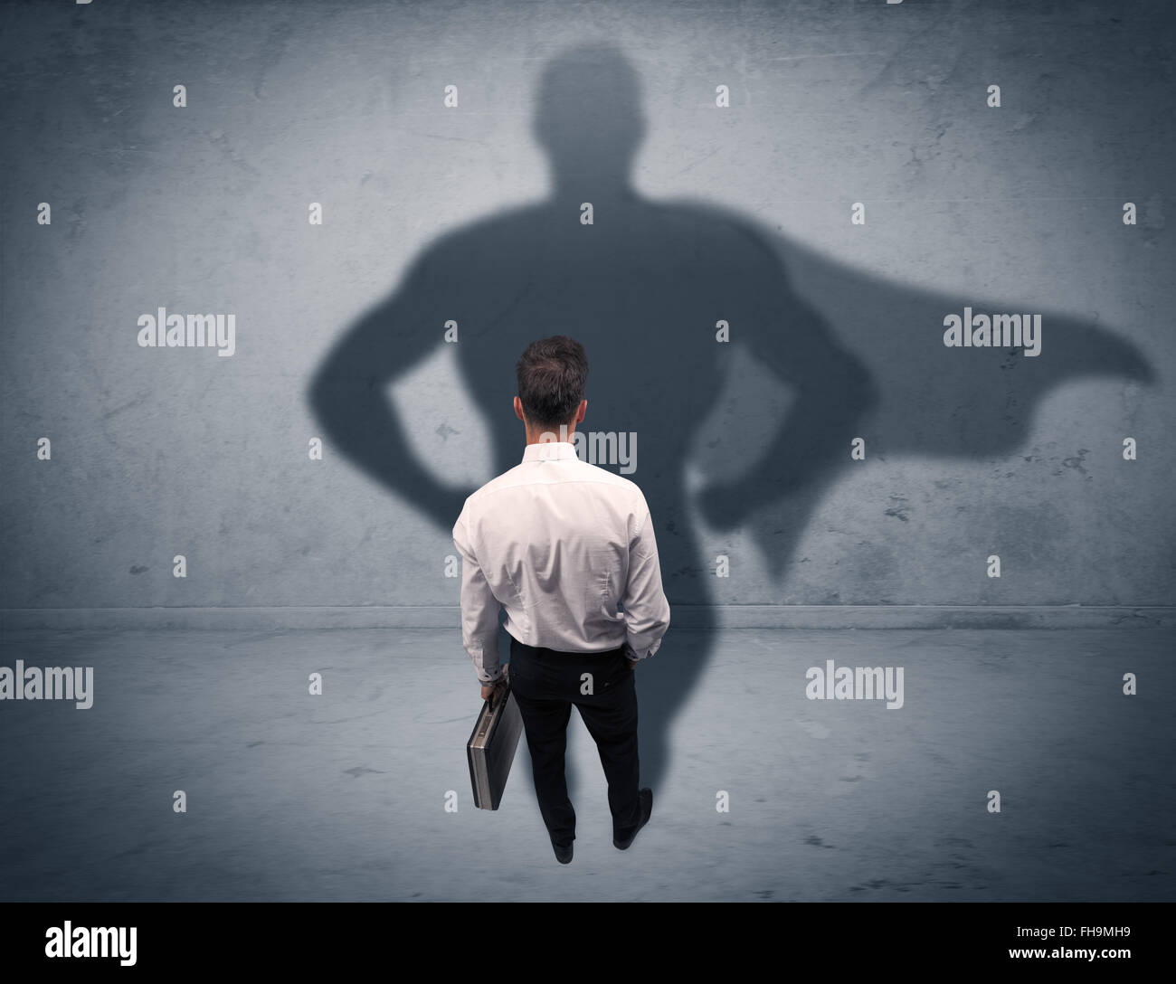 Successful businessman with superhero shadow Stock Photo - Alamy