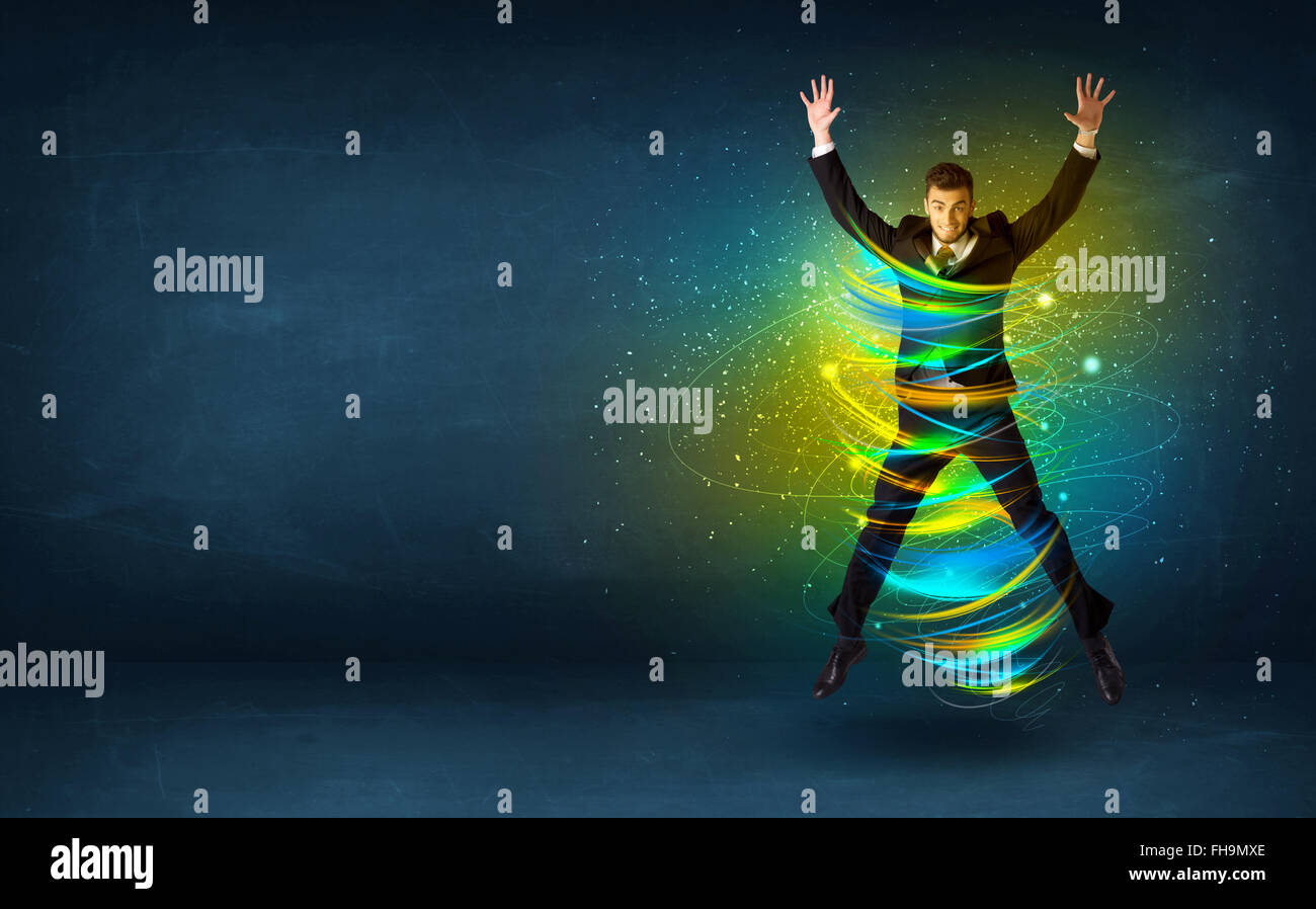 Excited business man jumping with energy colourful lines Stock Photo ...