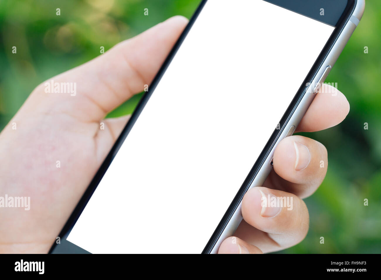 Closeup hand holding phone white screen outdoor Stock Photo - Alamy