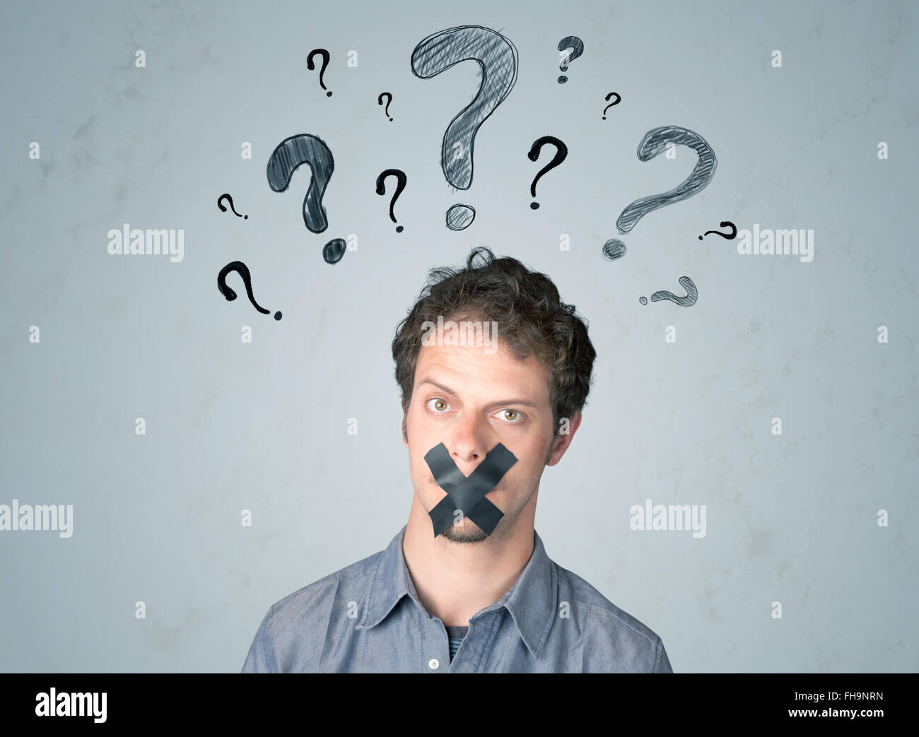 Young man with glued mouth and question mark symbols Stock Photo - Alamy