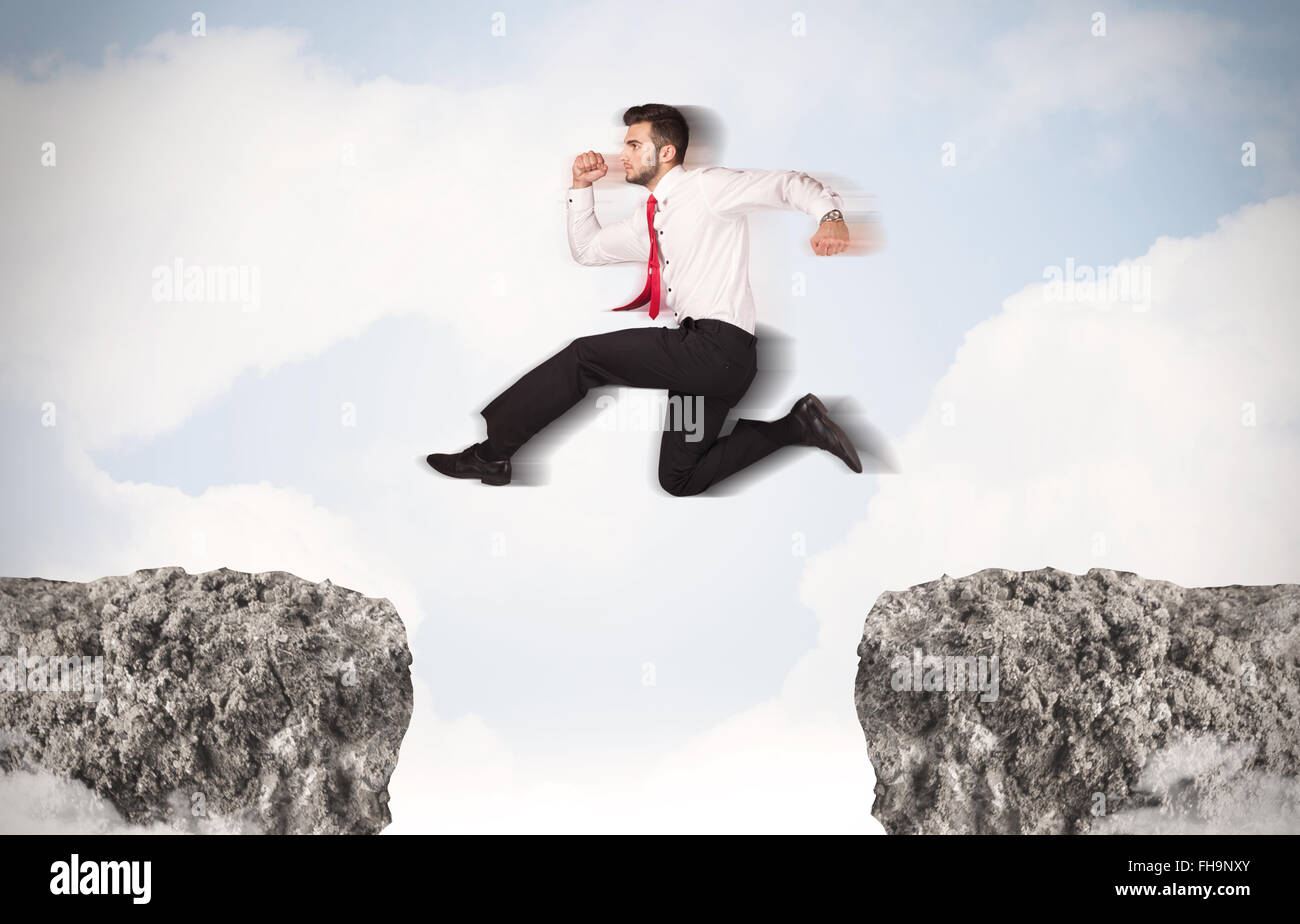Funny business man jumping over rocks with gap Stock Photo - Alamy