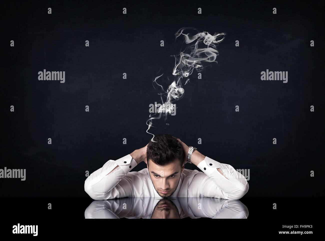 Depressed businessman with smoking head Stock Photo - Alamy
