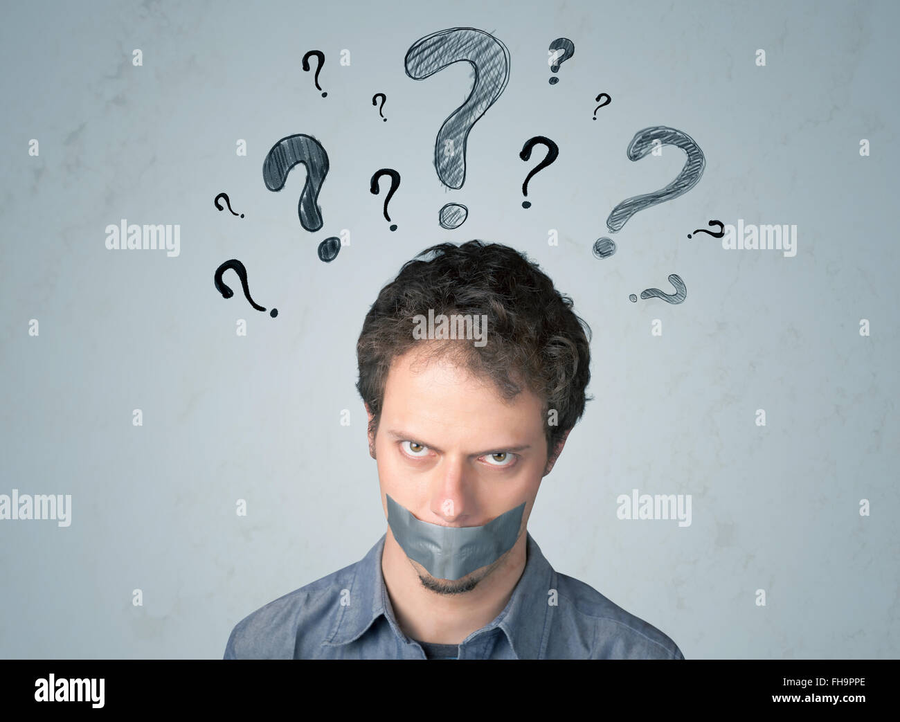 Young man with glued mouth and question mark symbols Stock Photo - Alamy