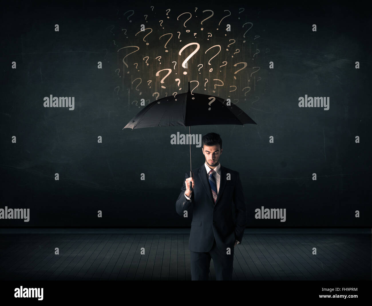 Businessman with umbrella and a lot of drawn question marks Stock Photo ...
