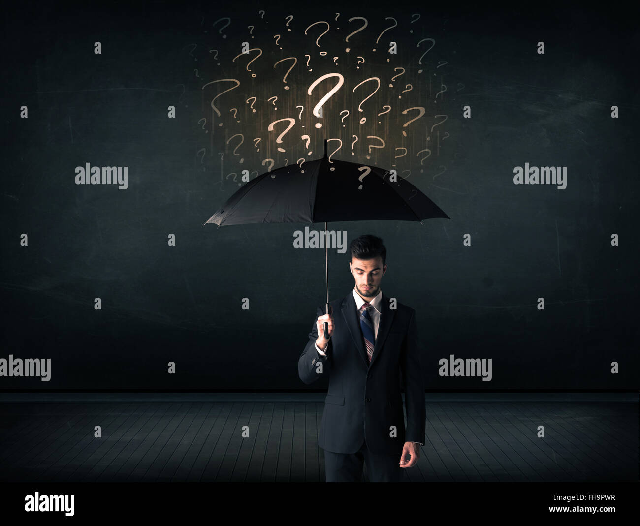 Businessman with umbrella and a lot of drawn question marks Stock Photo ...
