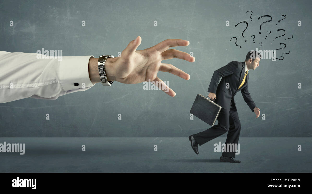 Businessman with question marks running away from a big hand Stock ...