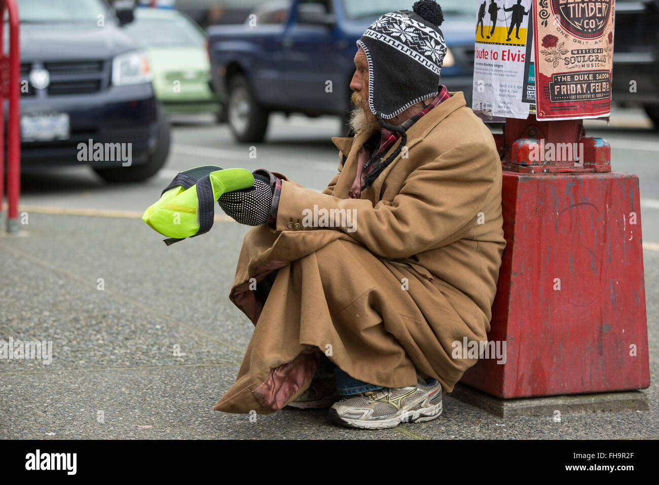 Elderly male panhandler on street corner in Chinatown-Victoria, British ...