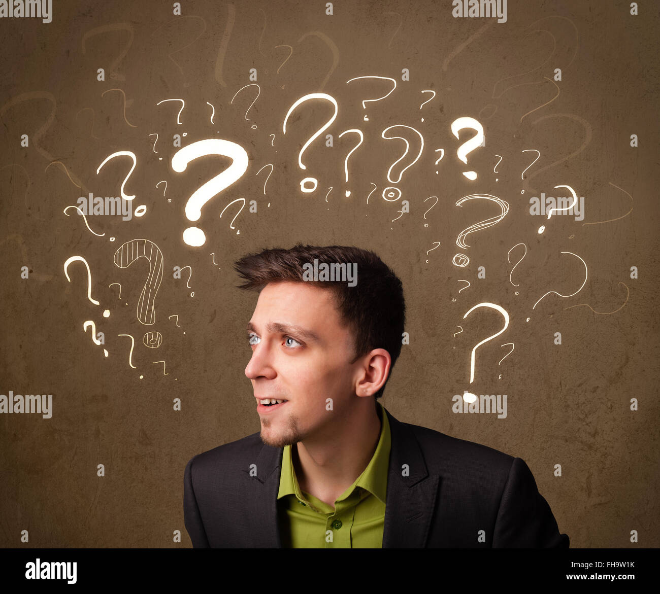 man with question mark symbols around his head Stock Photo - Alamy