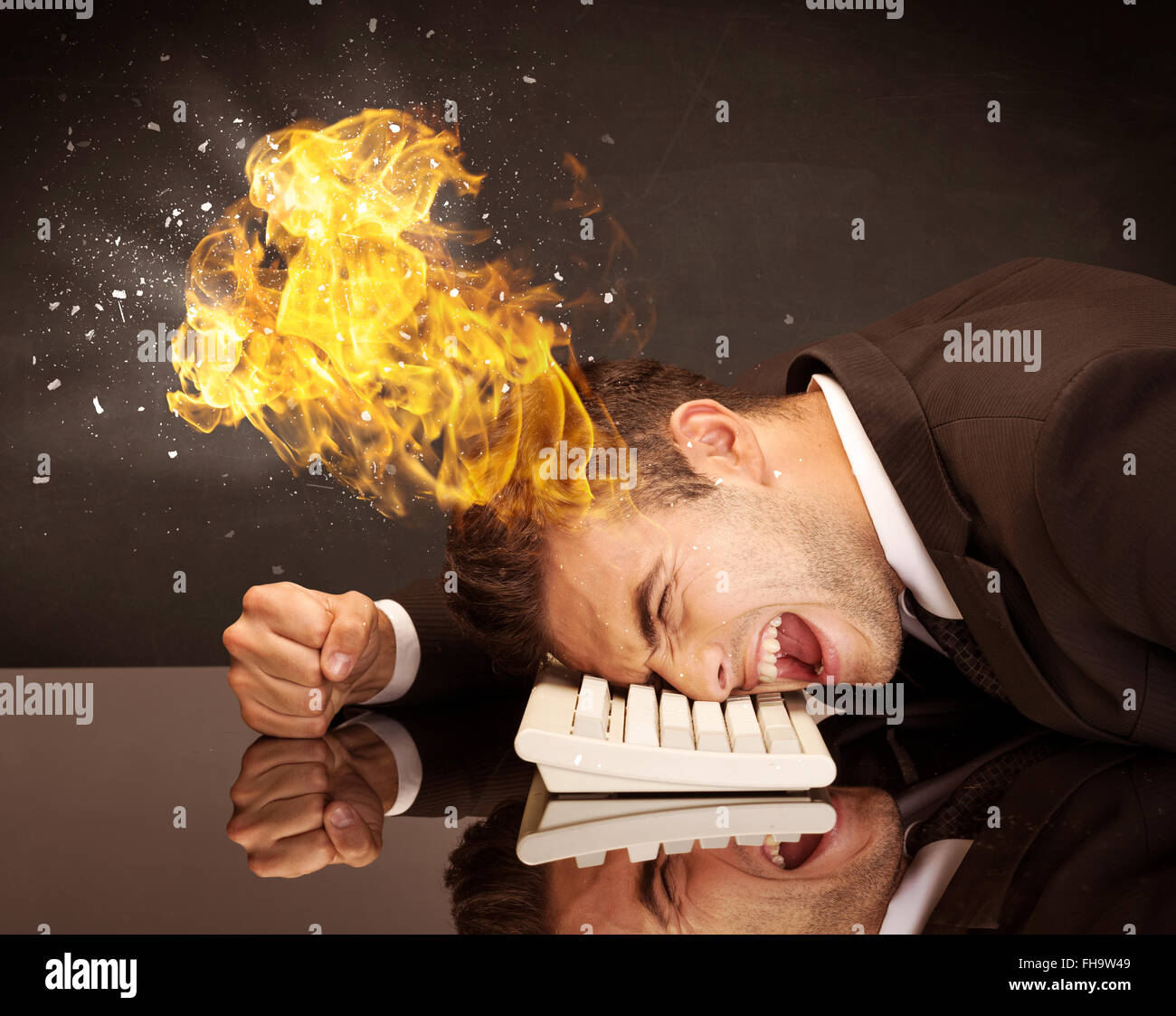 Stressed business man's head is burning Stock Photo - Alamy