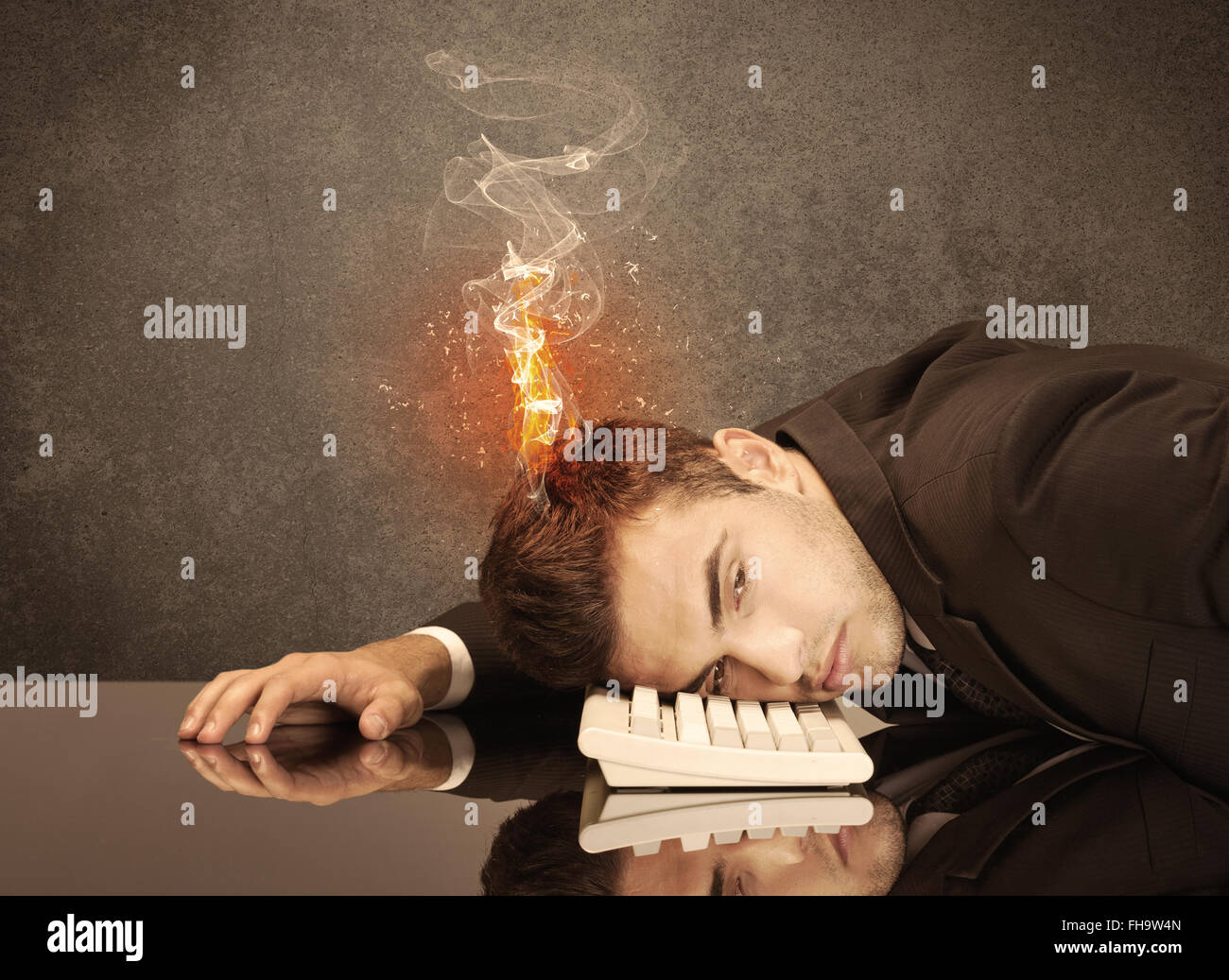 Sad business person's head catching fire Stock Photo - Alamy