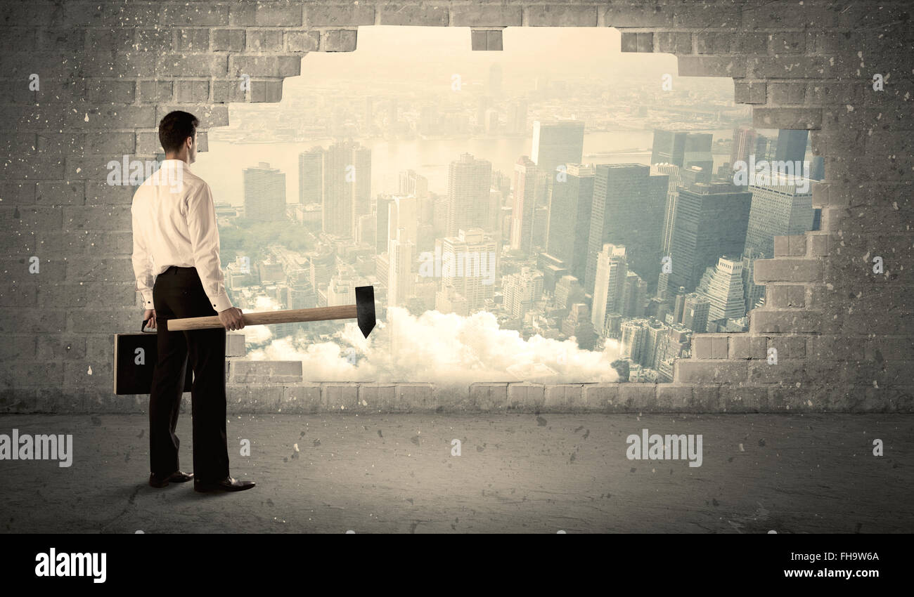 Business man hitting wall with hammer on city view Stock Photo - Alamy