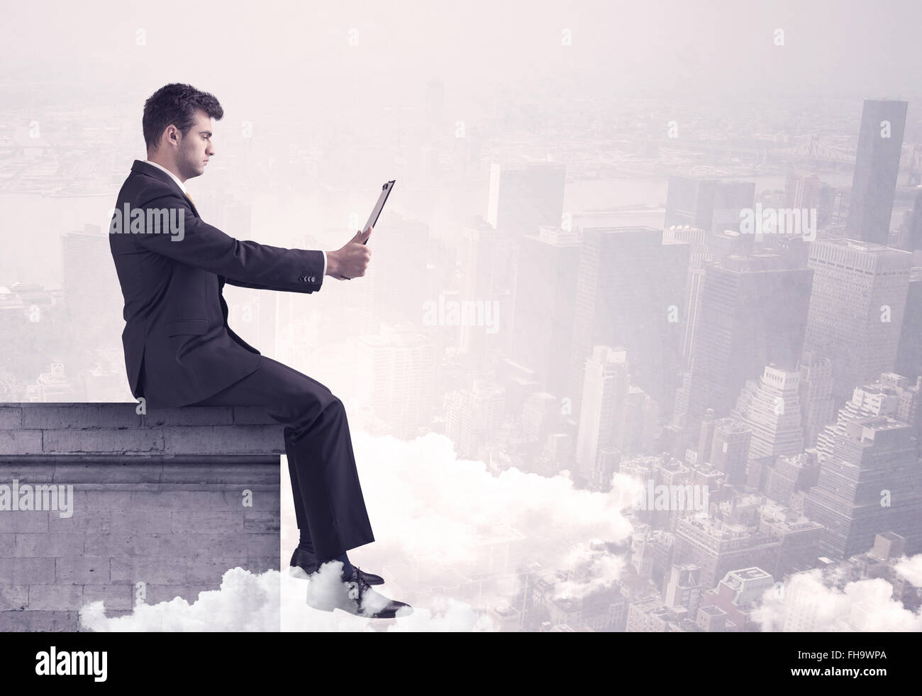 Sitting on building edge hi-res stock photography and images - Alamy