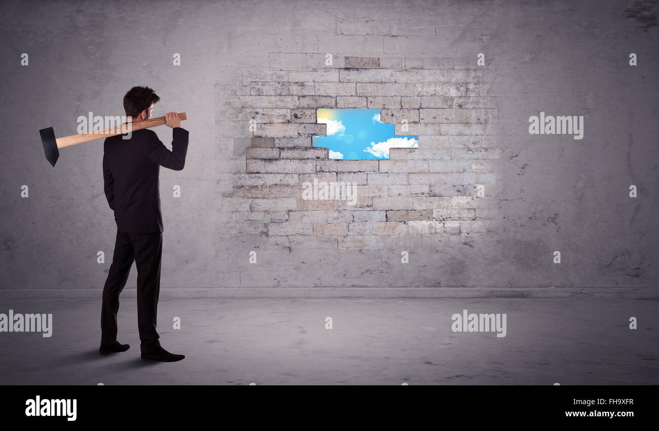 Business man hitting brick wall with hammer Stock Photo - Alamy