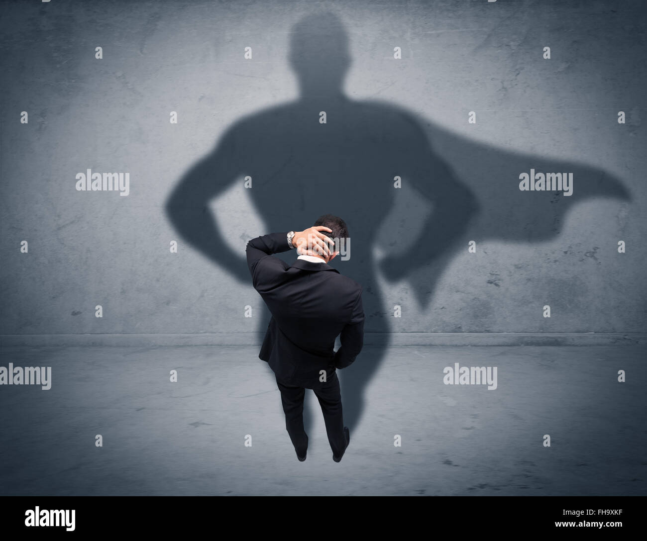 Successful businessman with superhero shadow Stock Photo - Alamy