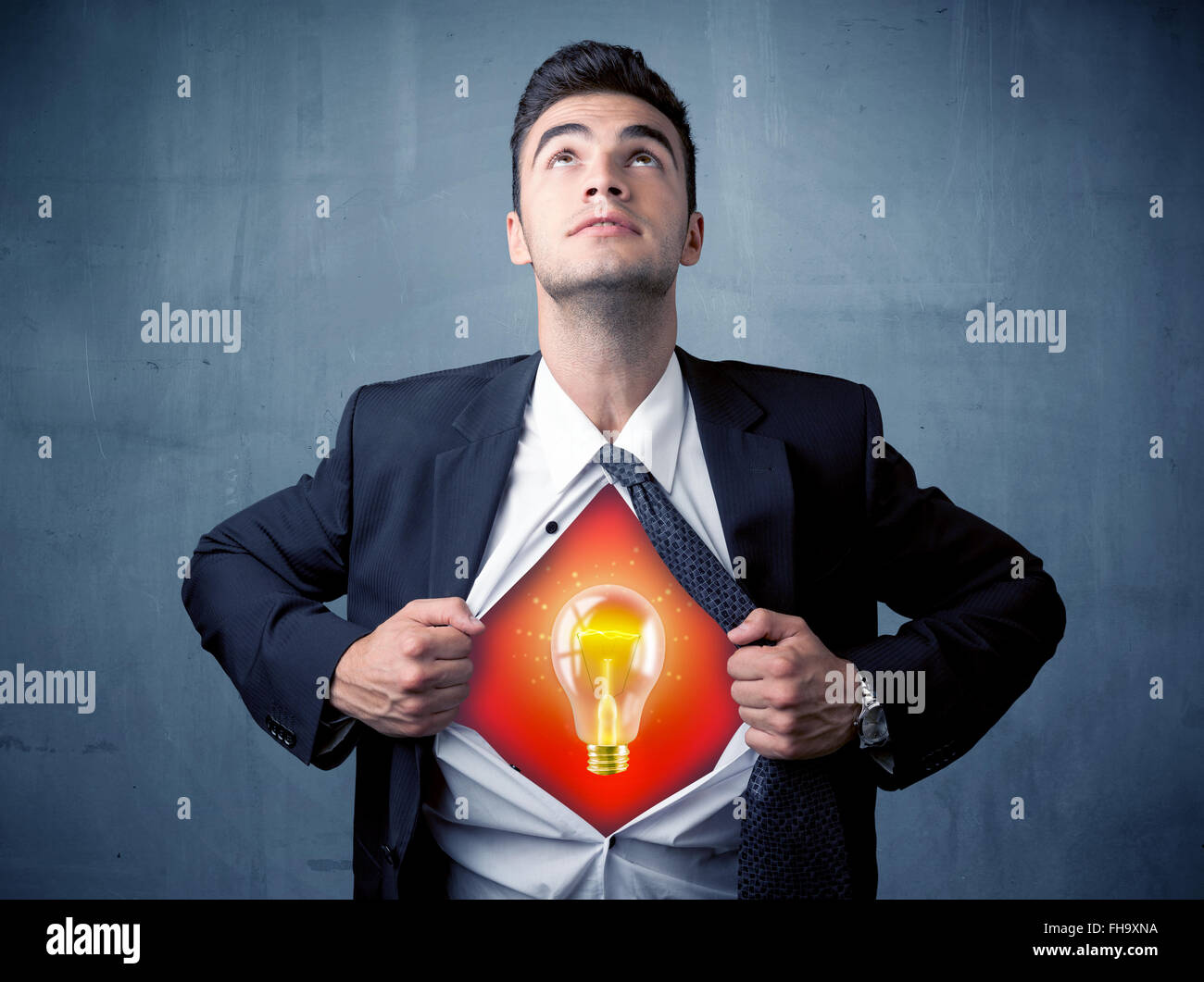 Businessman ripping off shirt and idea light bulb appears Stock Photo ...