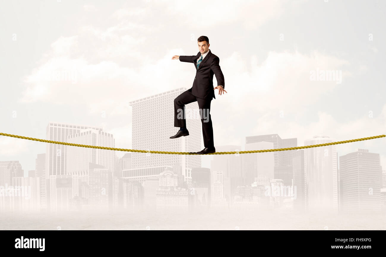 Business person balancing on golden rope Stock Photo - Alamy