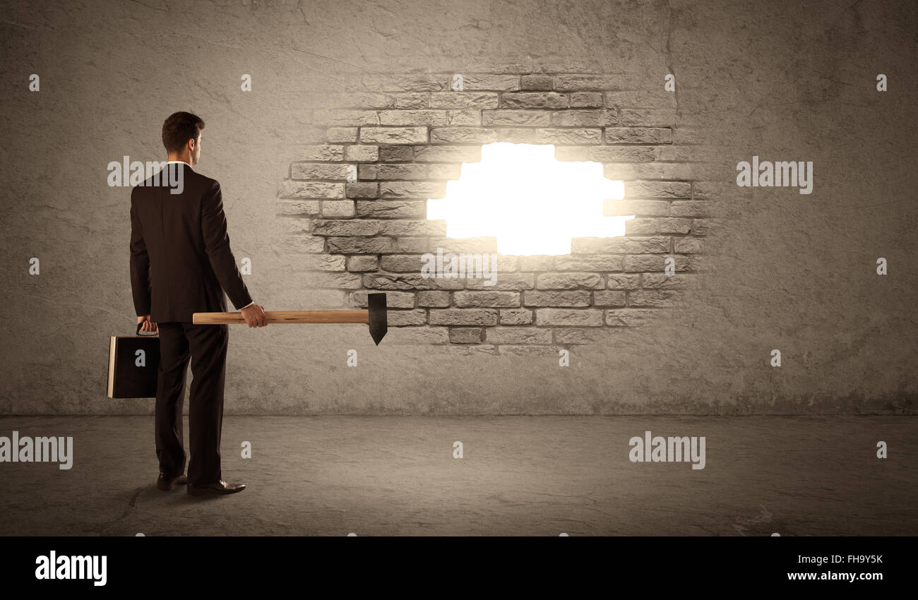 Business man hitting brick wall with hammer and opening a hole Stock ...
