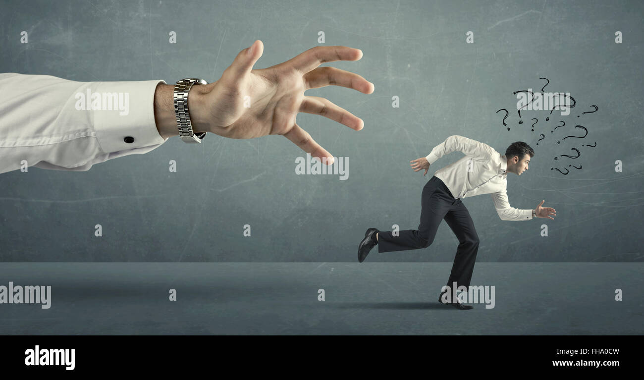 Businessman running away from a big hand Stock Photo - Alamy