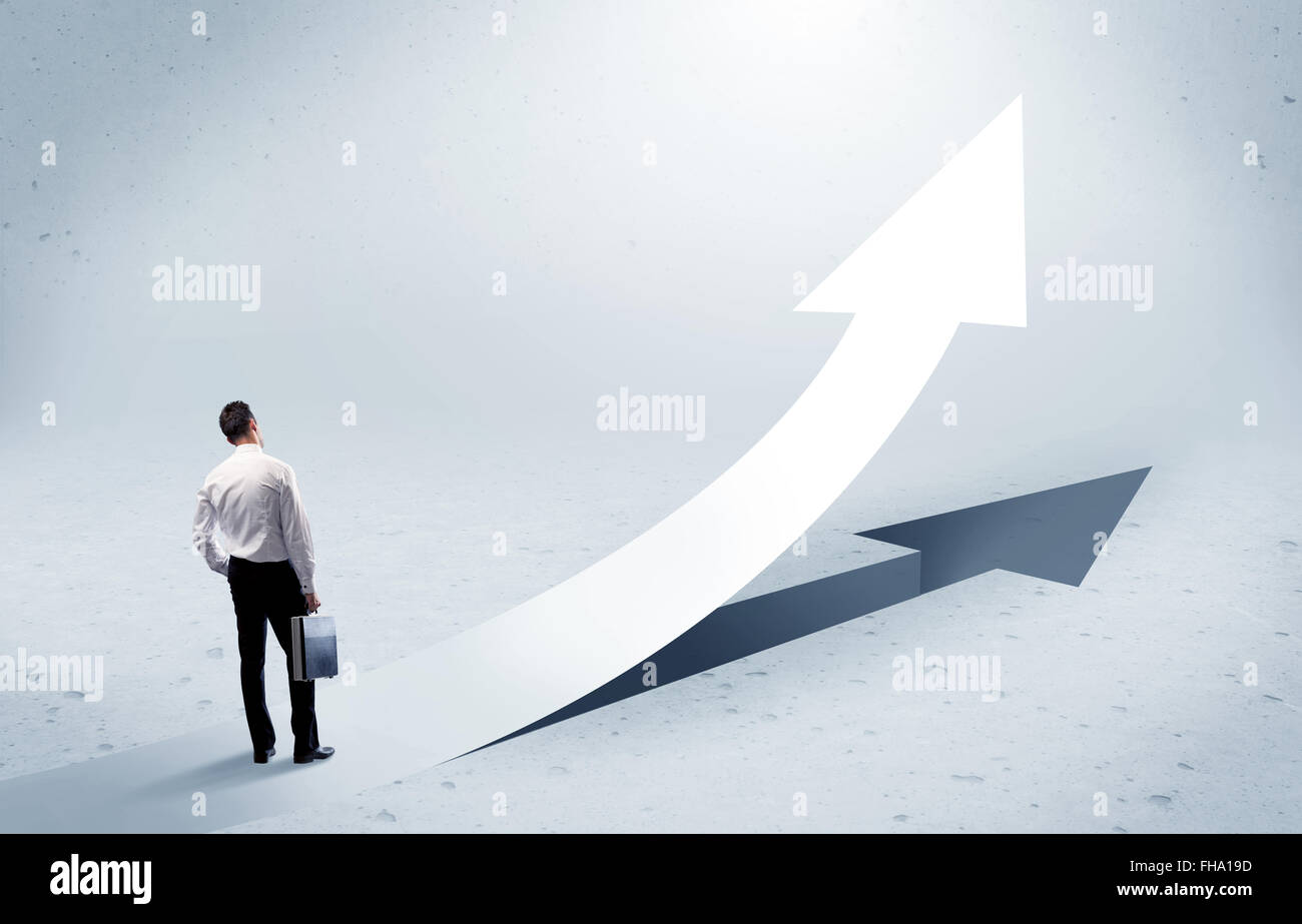 Arrow pointing up with standing salesman Stock Photo - Alamy