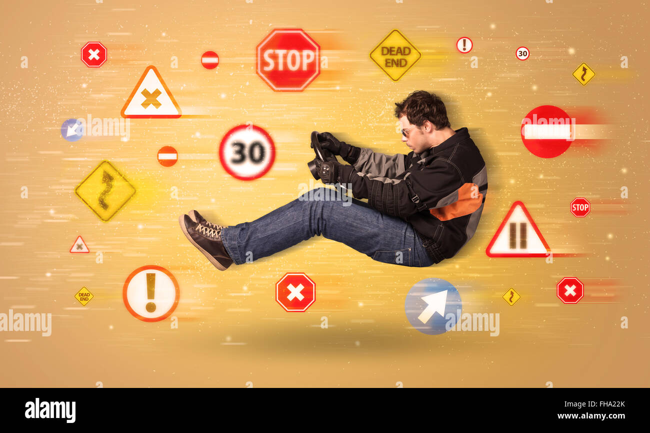 Young driver with road signs around him Stock Photo - Alamy