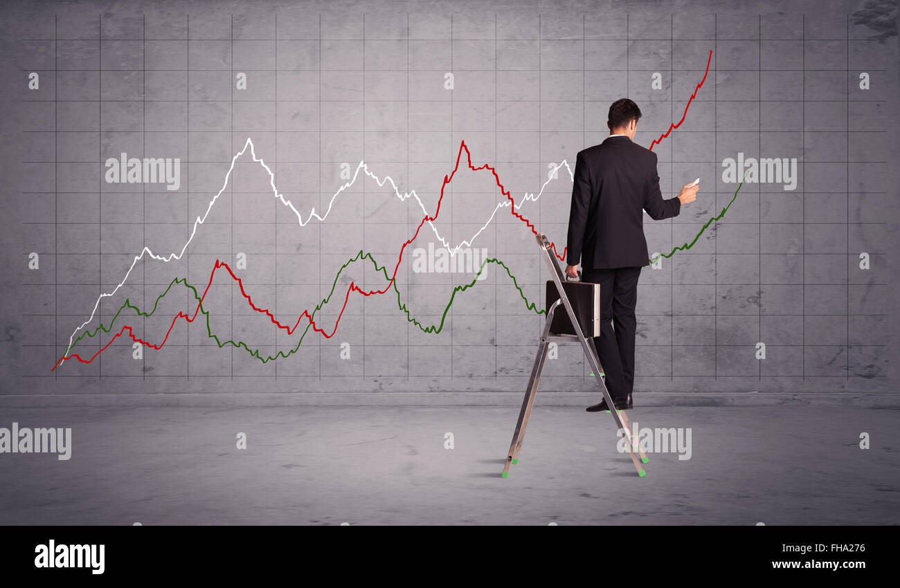 male on ladder drawing chart lines Stock Photo - Alamy