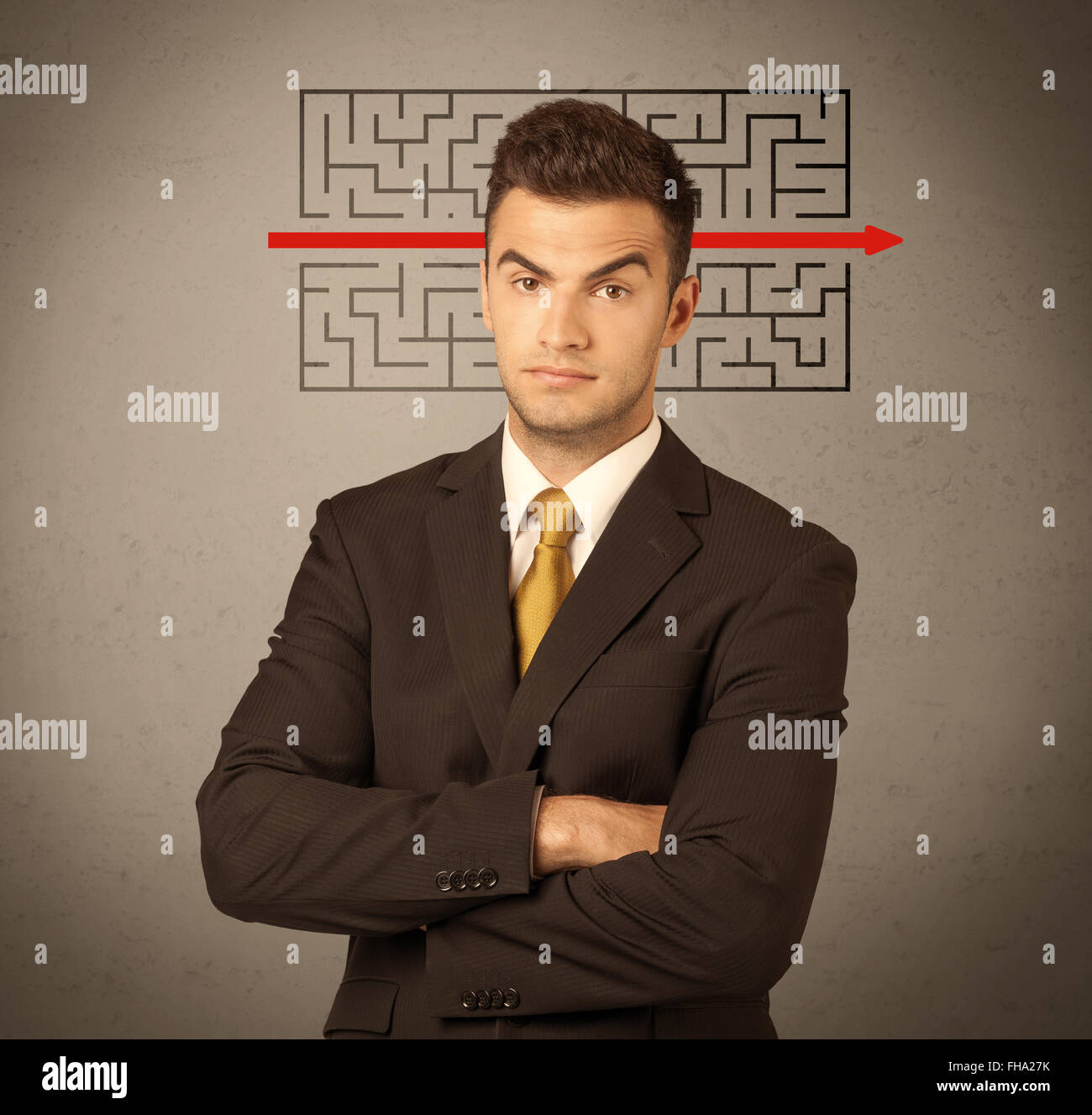 Handsome business guy solving maze Stock Photo - Alamy